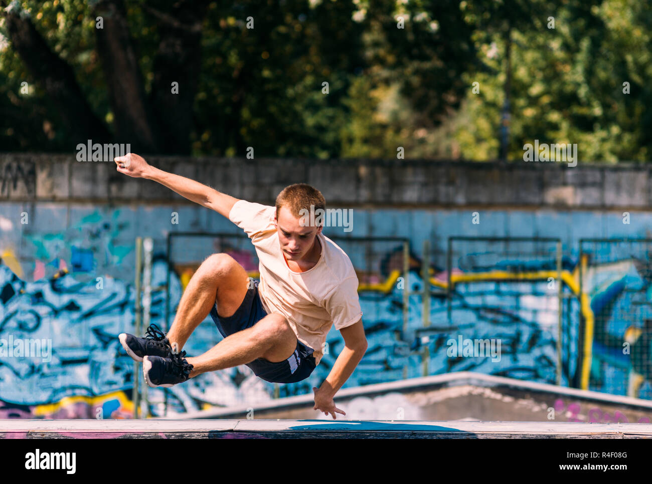 Acrobat man training parkour exercise while jumping obstacles Stock ...