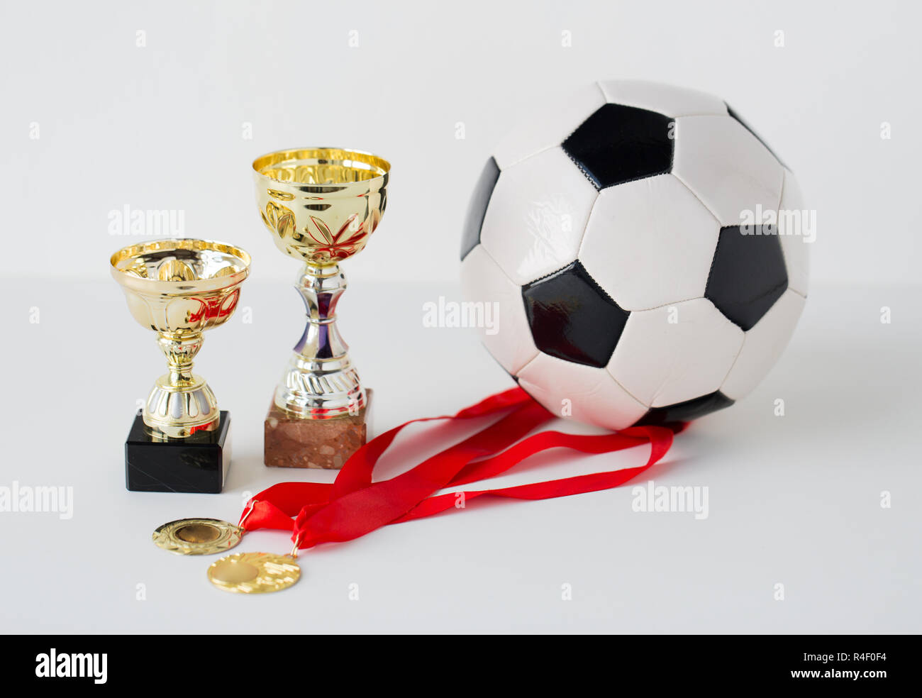 close up of football ball, golden cups and medals Stock Photo - Alamy