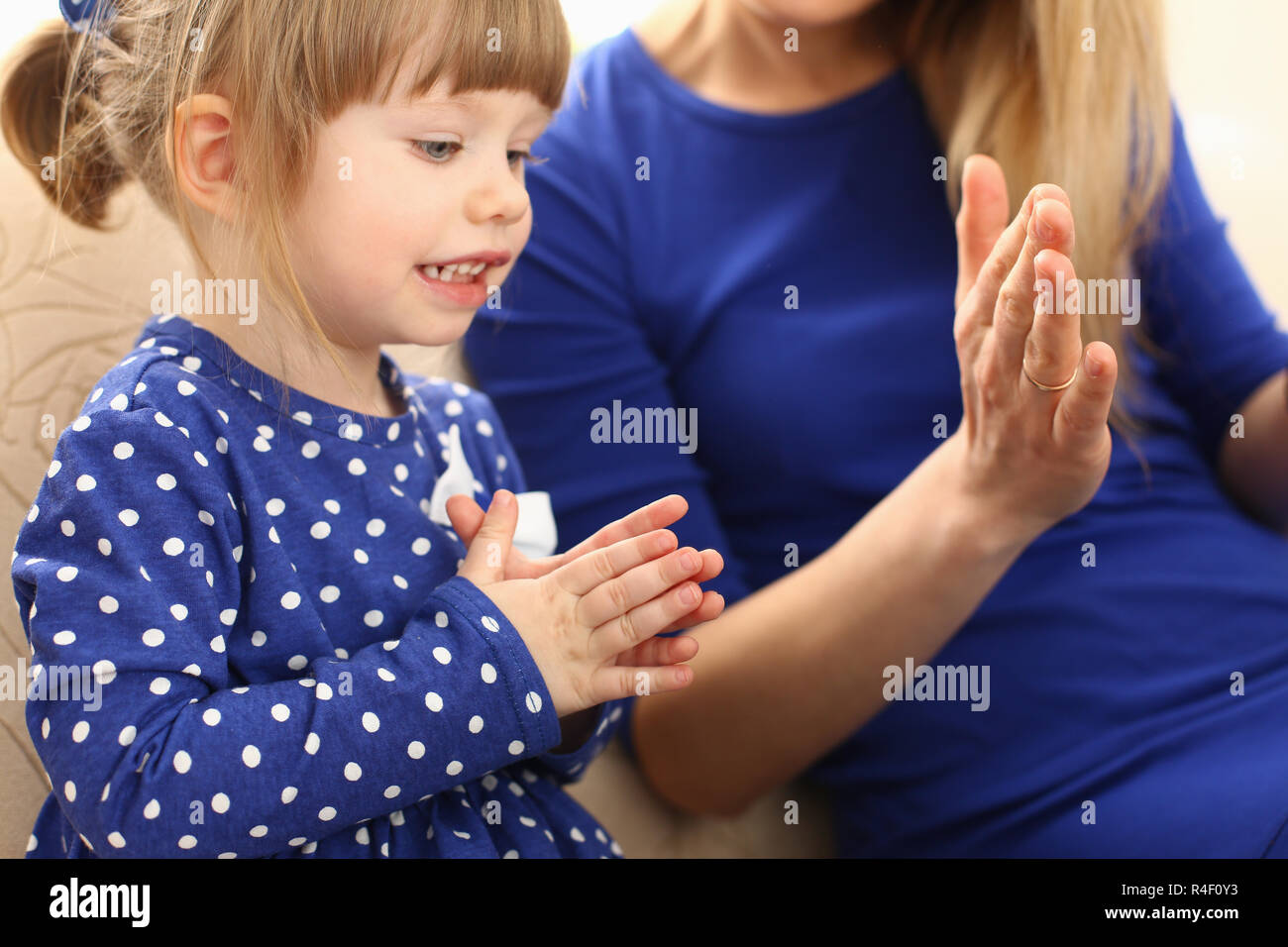 Cute little girl play with mom pat-a-cake Stock Photo - Alamy