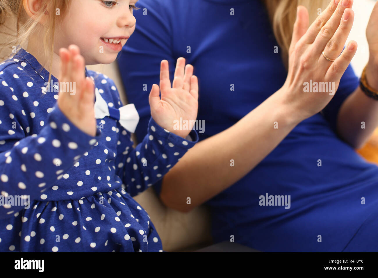 Cute little girl play with mom pat-a-cake Stock Photo - Alamy