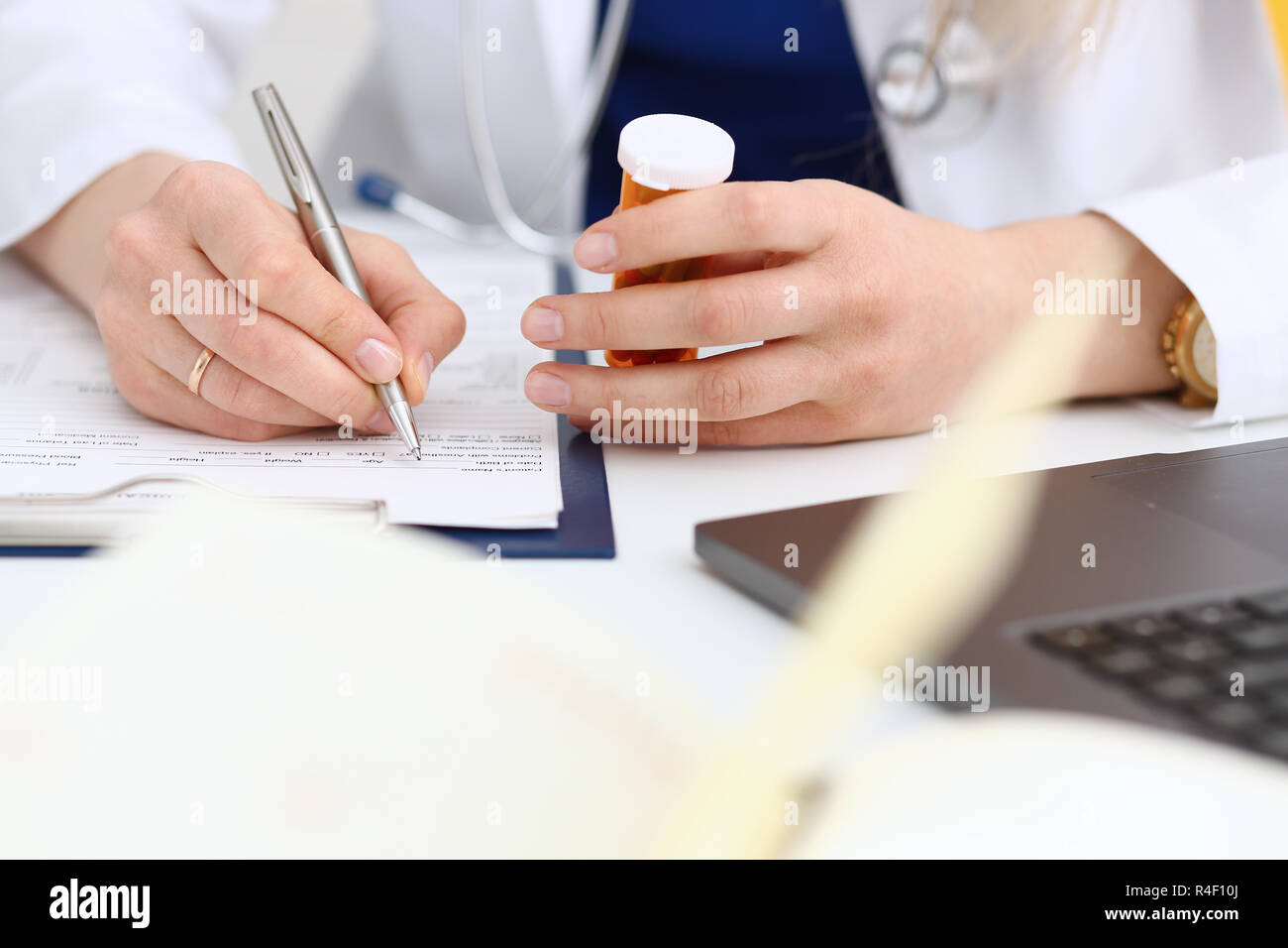 Female medicine doctor hand hold jar of pills Stock Photo - Alamy
