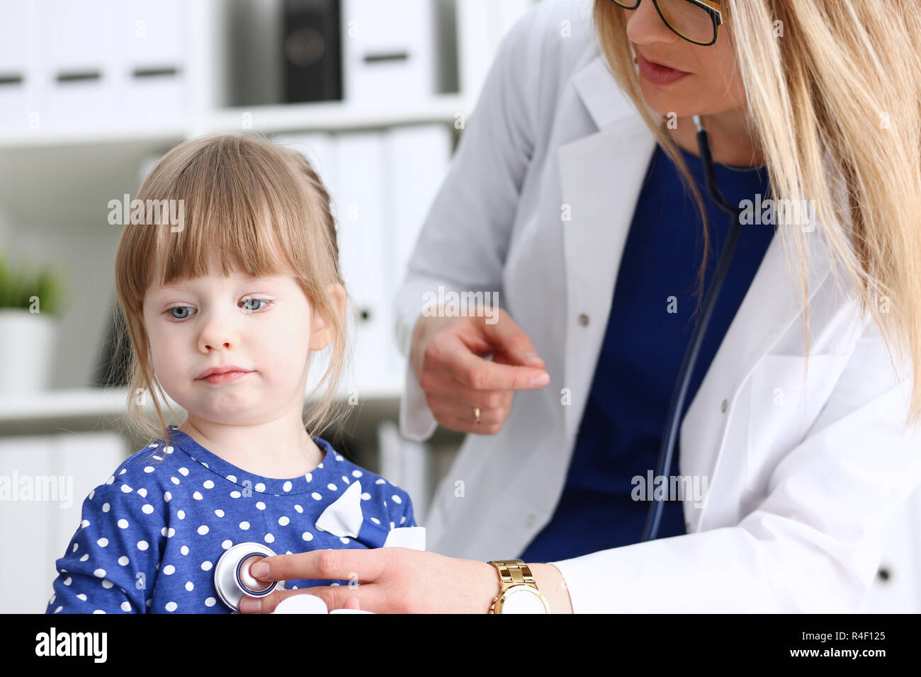 Little child with stethoscope at doctor reception Stock Photo - Alamy