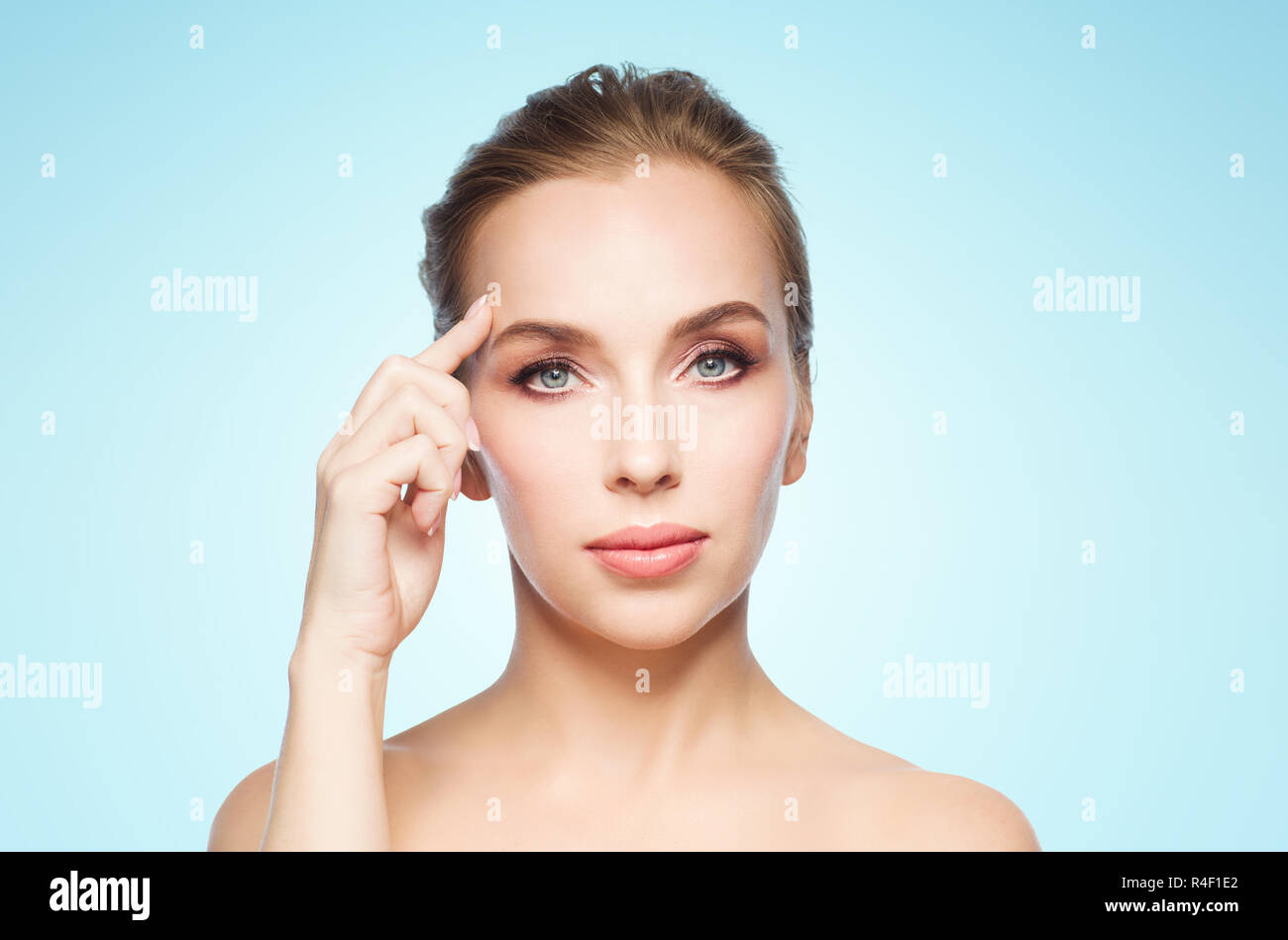 Beautiful woman pointing forehead hi-res stock photography and images ...