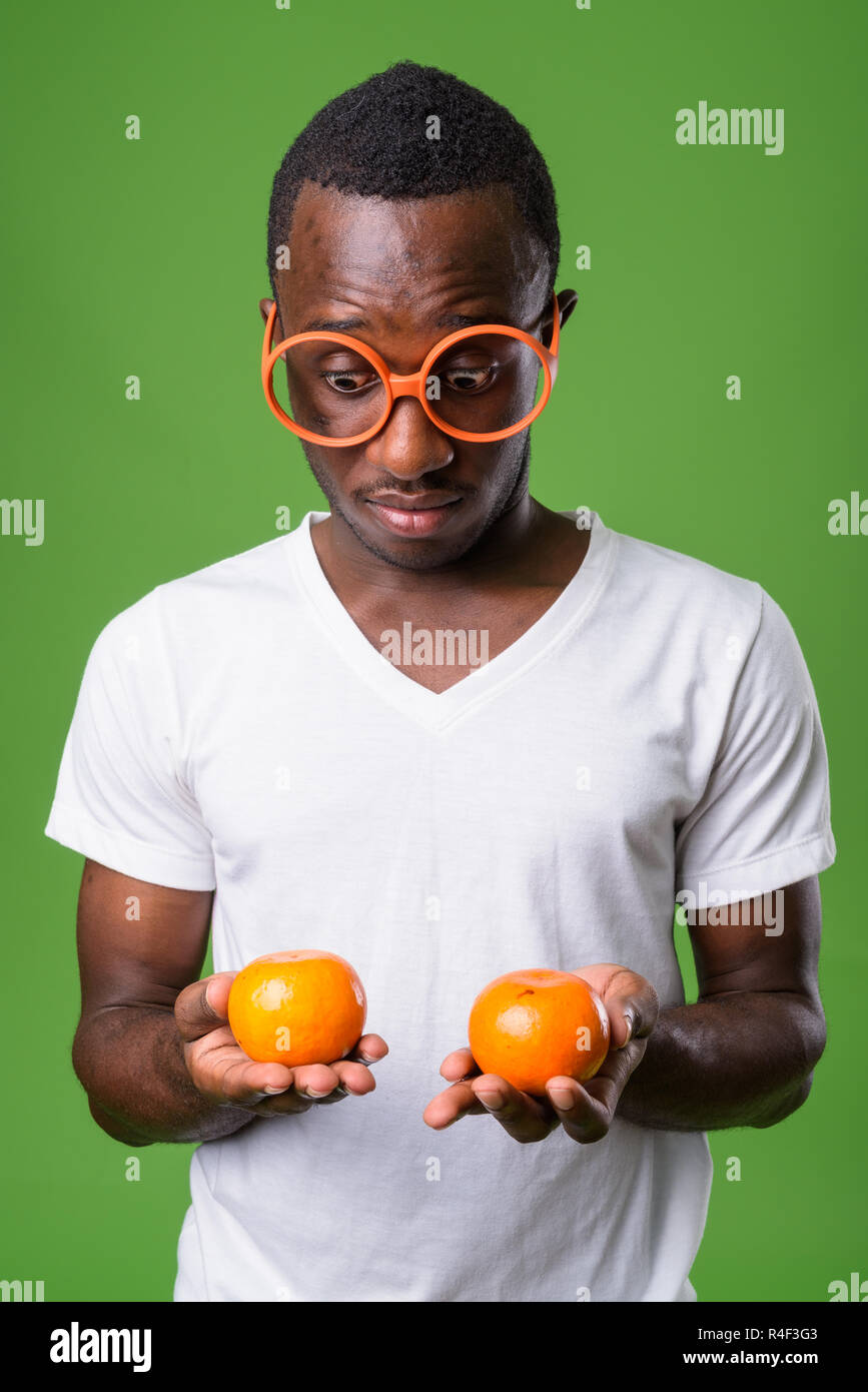 Studio shot of young African man against green background Stock Photo ...