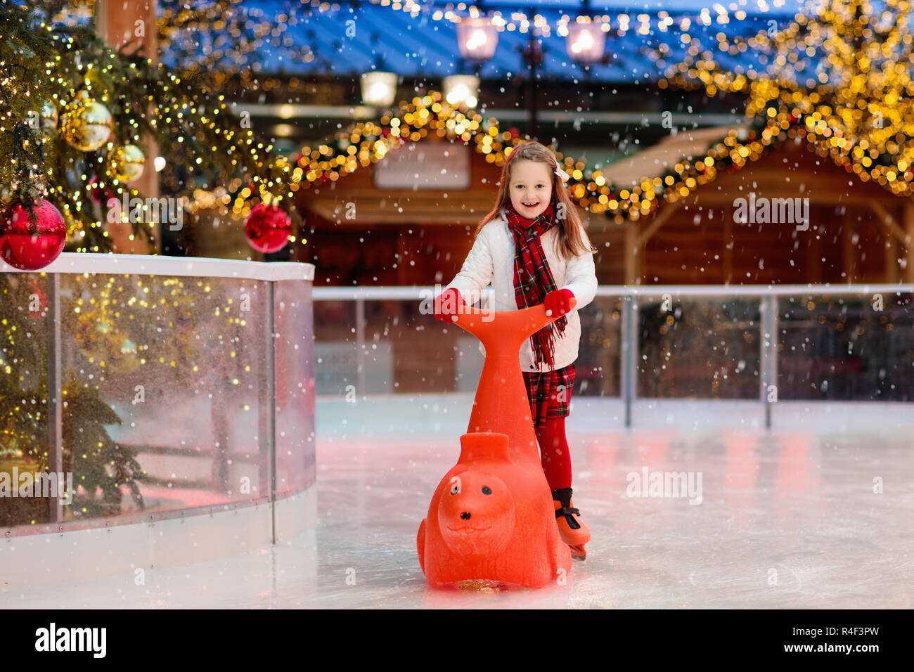 Kids ice skating in winter park rink. Children ice skate on Christmas ...