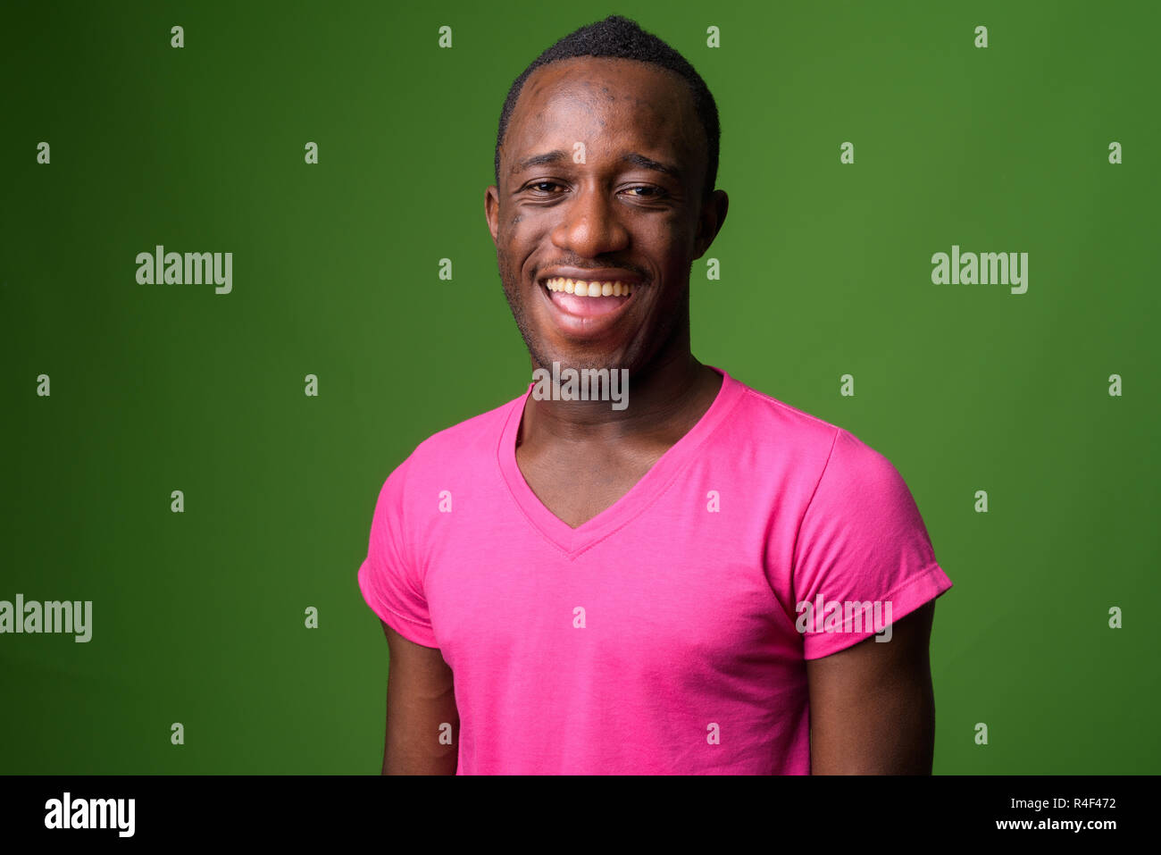 Studio shot of young African man against green background Stock Photo ...