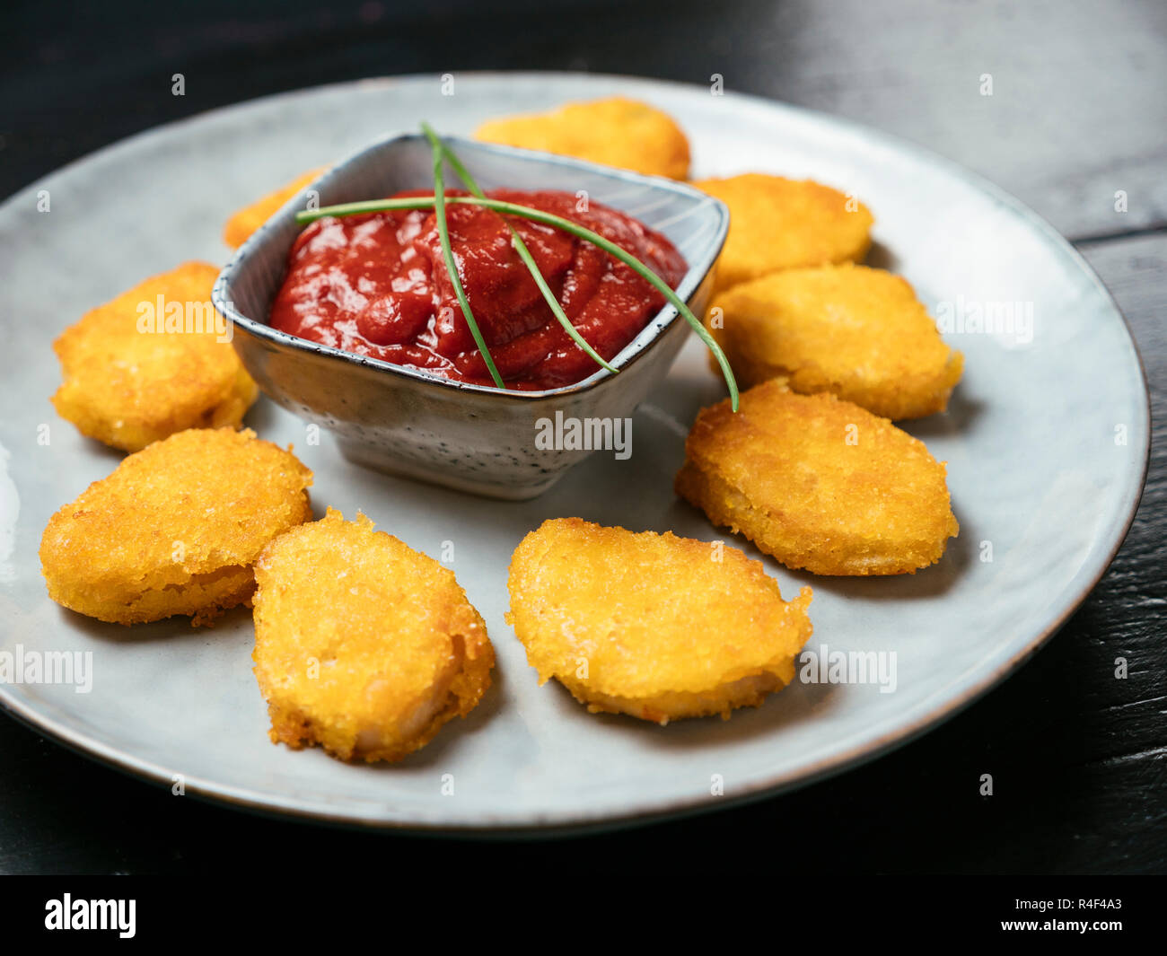 Soy nuggets on a plate, served with a spicy tomato dip Stock Photo - Alamy