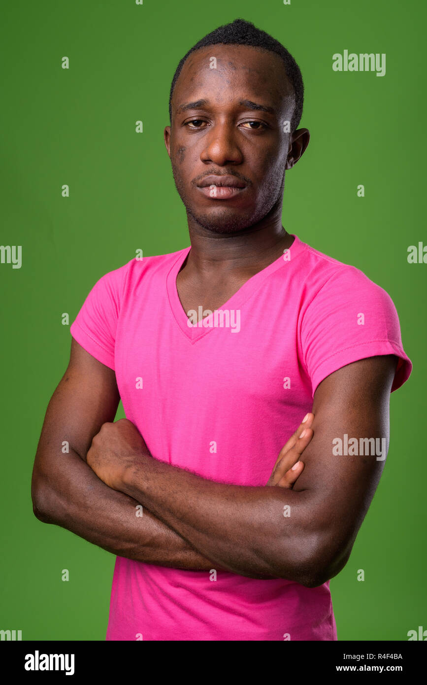 Studio shot of young African man against green background Stock Photo ...