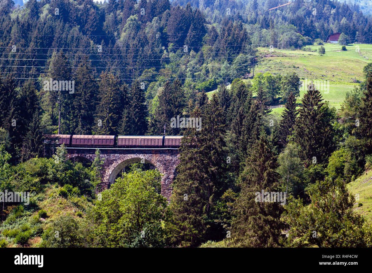 A picturesque Alpine landscape with an old railway bridge. Austria ...