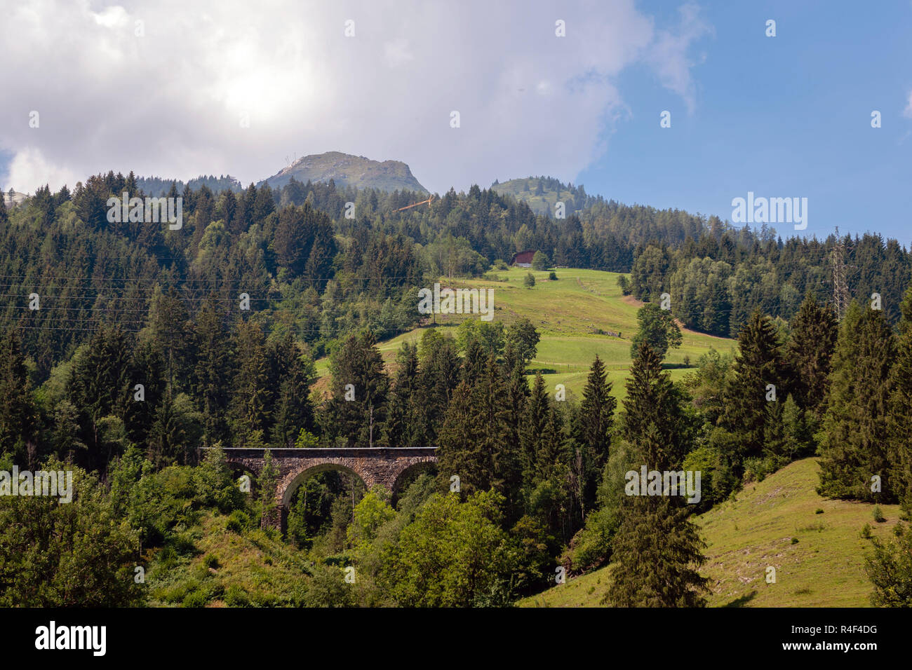 A picturesque Alpine landscape with an old railway bridge. Austria ...