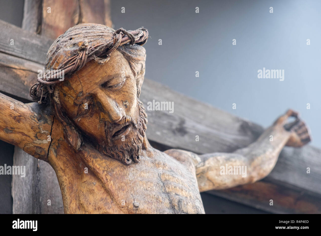 Holy Crucified Jesus Christ close-up. Ancient wooden sculpture. Bottom view. Sacred figure Stock ...
