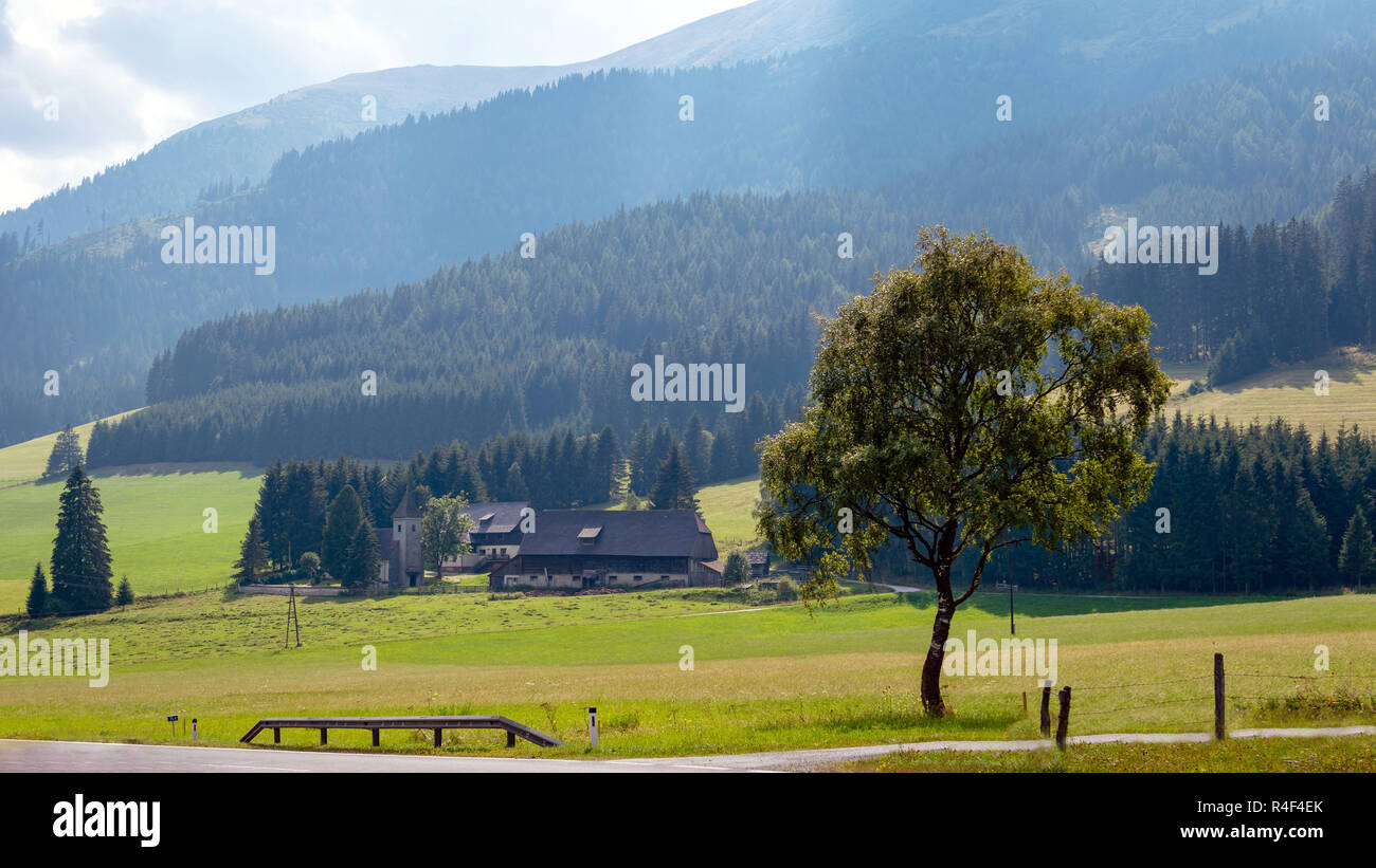 A typical small Austrian village at the foot of the Alpine mountains ...