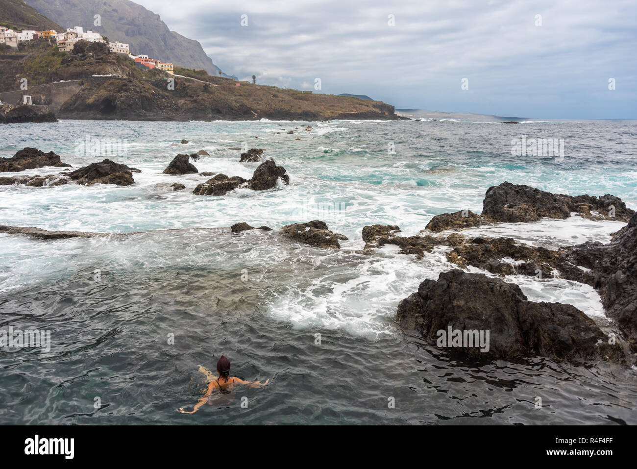 Girl swimming alone at Garachico, natural public swimming pool ...