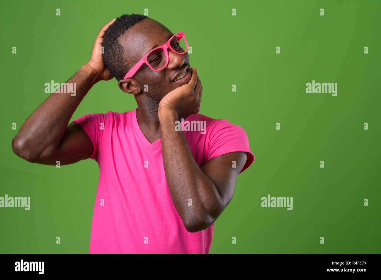 Studio shot of young African man against green background Stock Photo ...