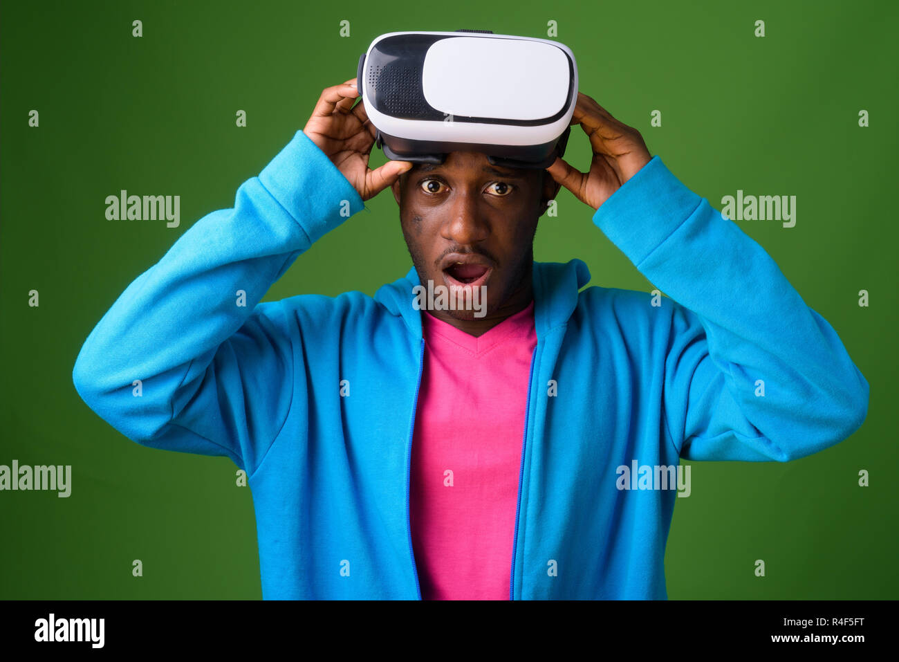Studio shot of young African man against green background Stock Photo ...
