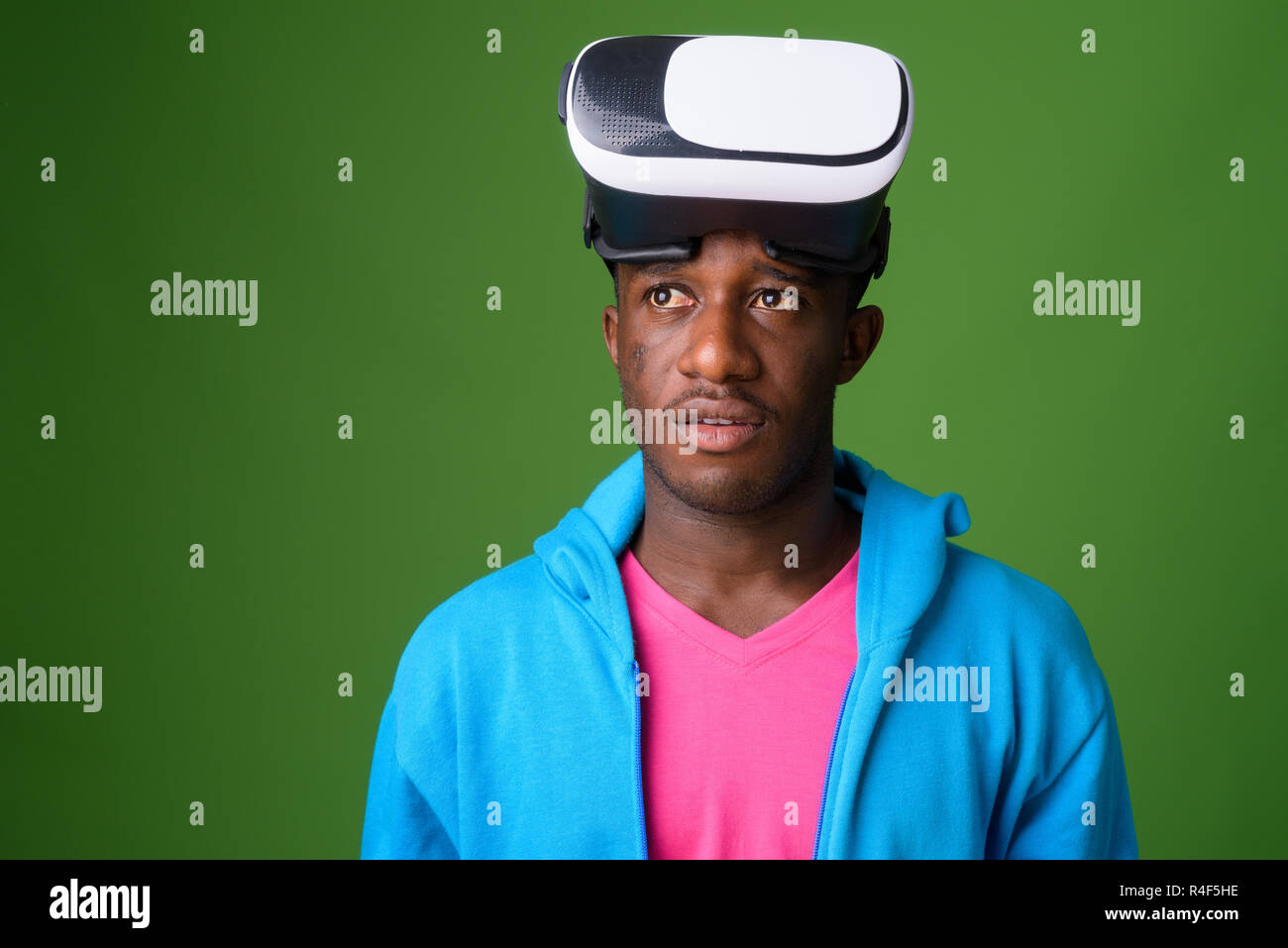 Studio shot of young African man against green background Stock Photo ...