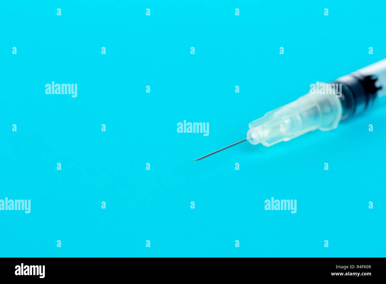 Insulin syringe on a blue background Stock Photo - Alamy