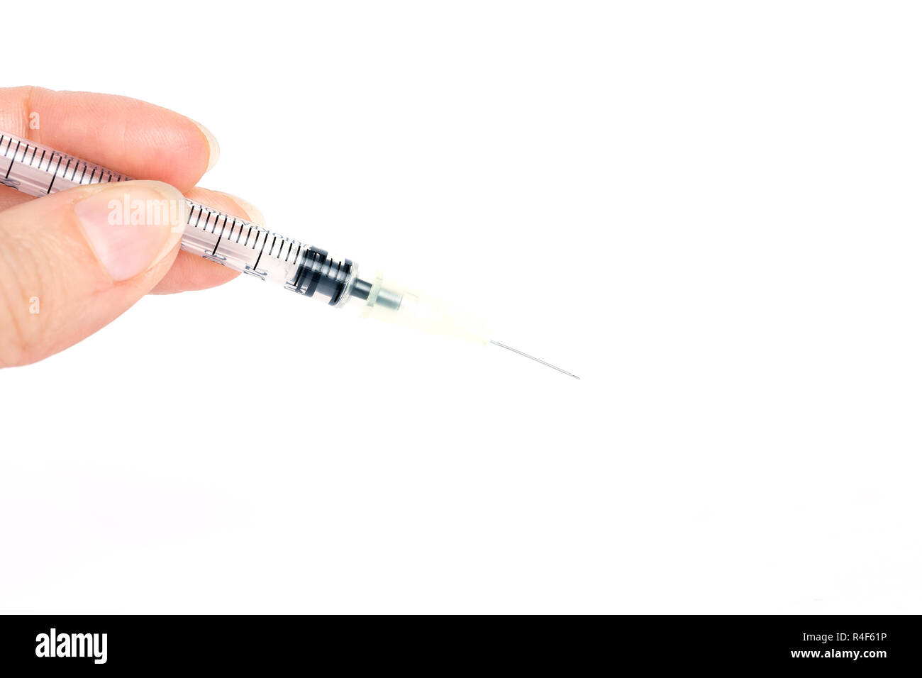 Female hands prepare an insulin syringe for work on a white background ...