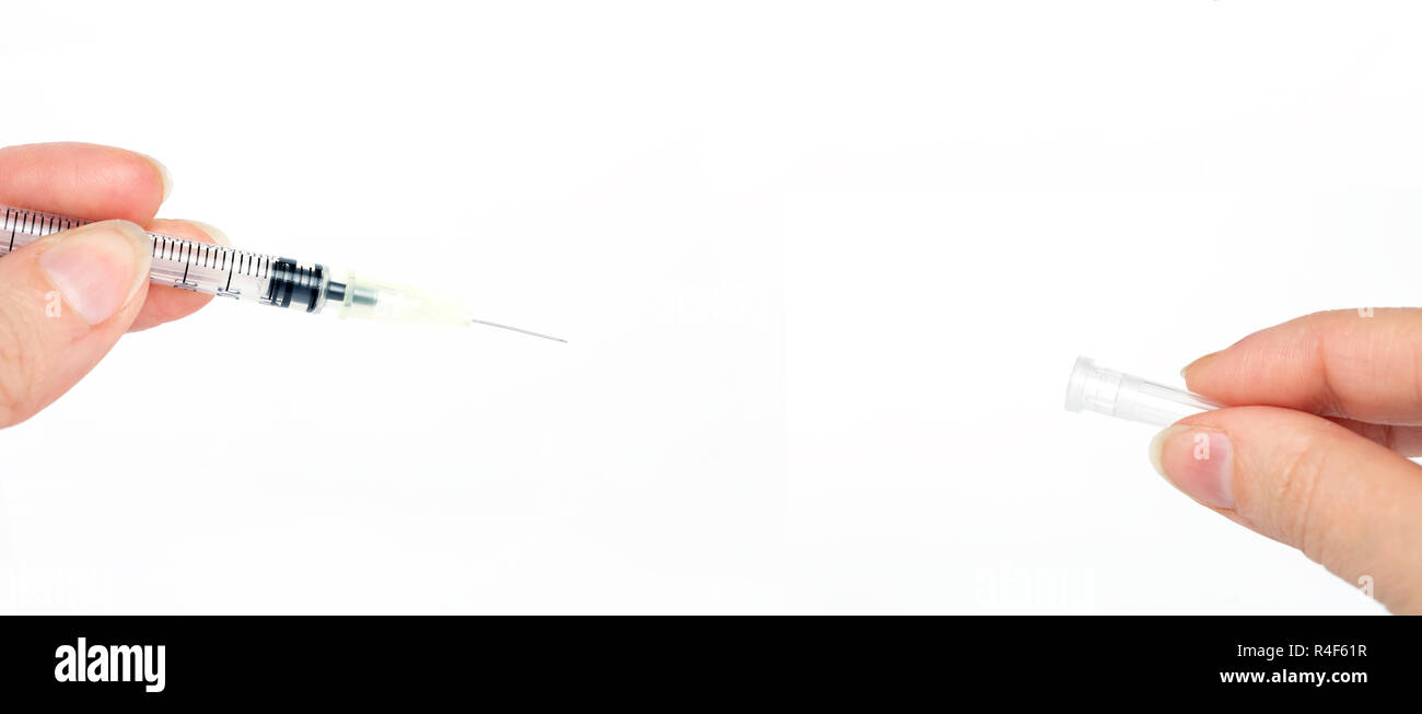 Female hands prepare an insulin syringe for work on a white background ...
