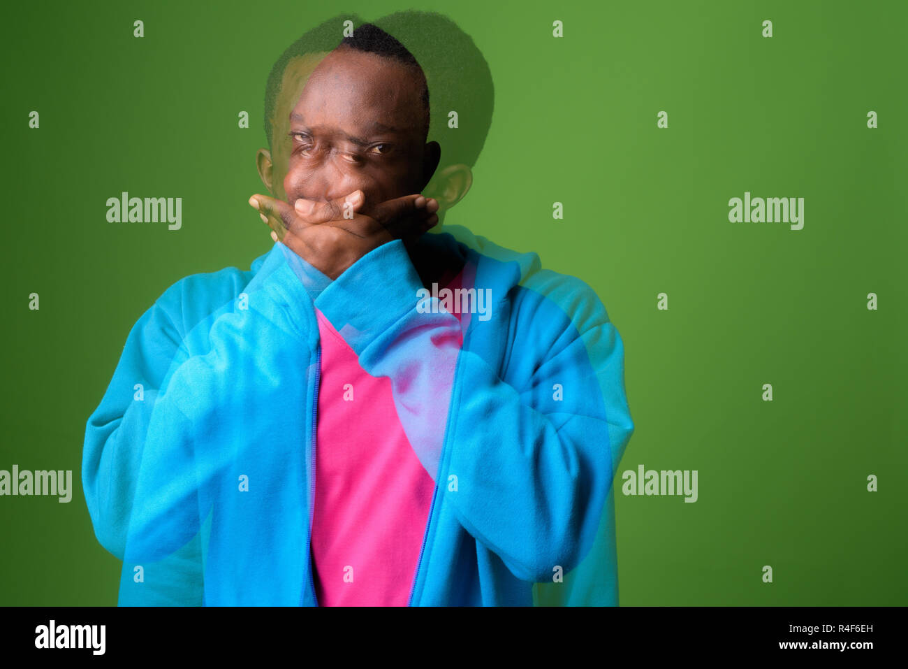 Double exposure shot of young African man against green background ...