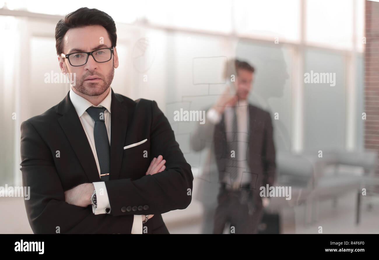 close up. serious businessman on the background of the office Stock ...