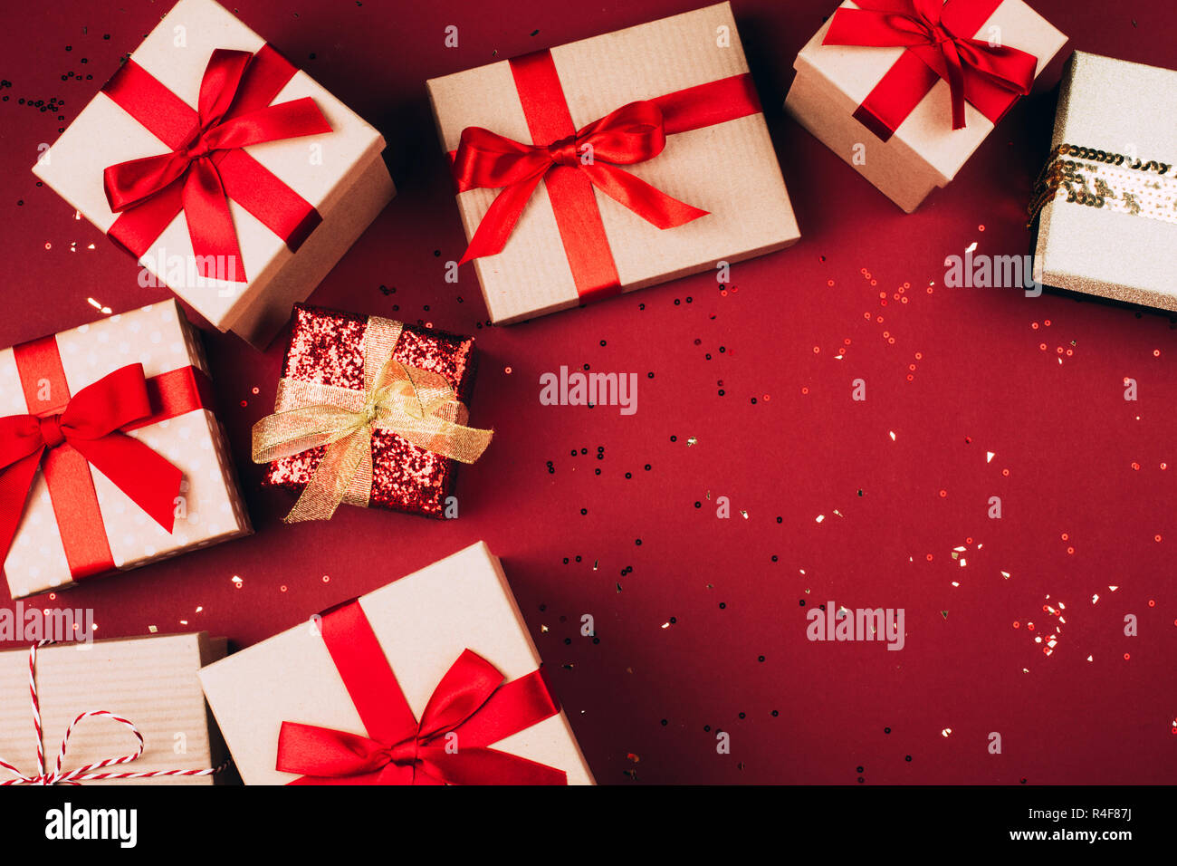 Many present boxes with red bow on red background. Flat lay style Stock ...