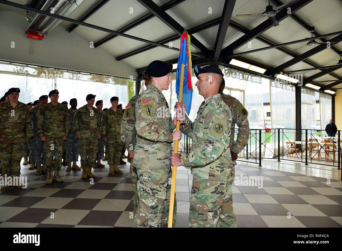 (From left) Capt. Lacey C. Enyart, Bravo Company commander, receives ...