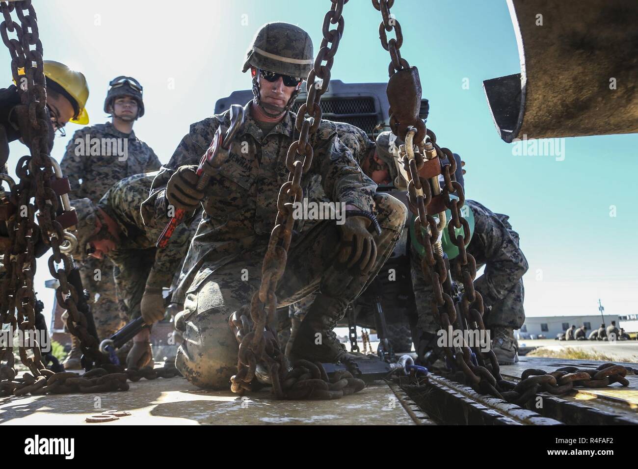 U.S. Marines with 2nd Marine Logistics Group fasten chains to a ...