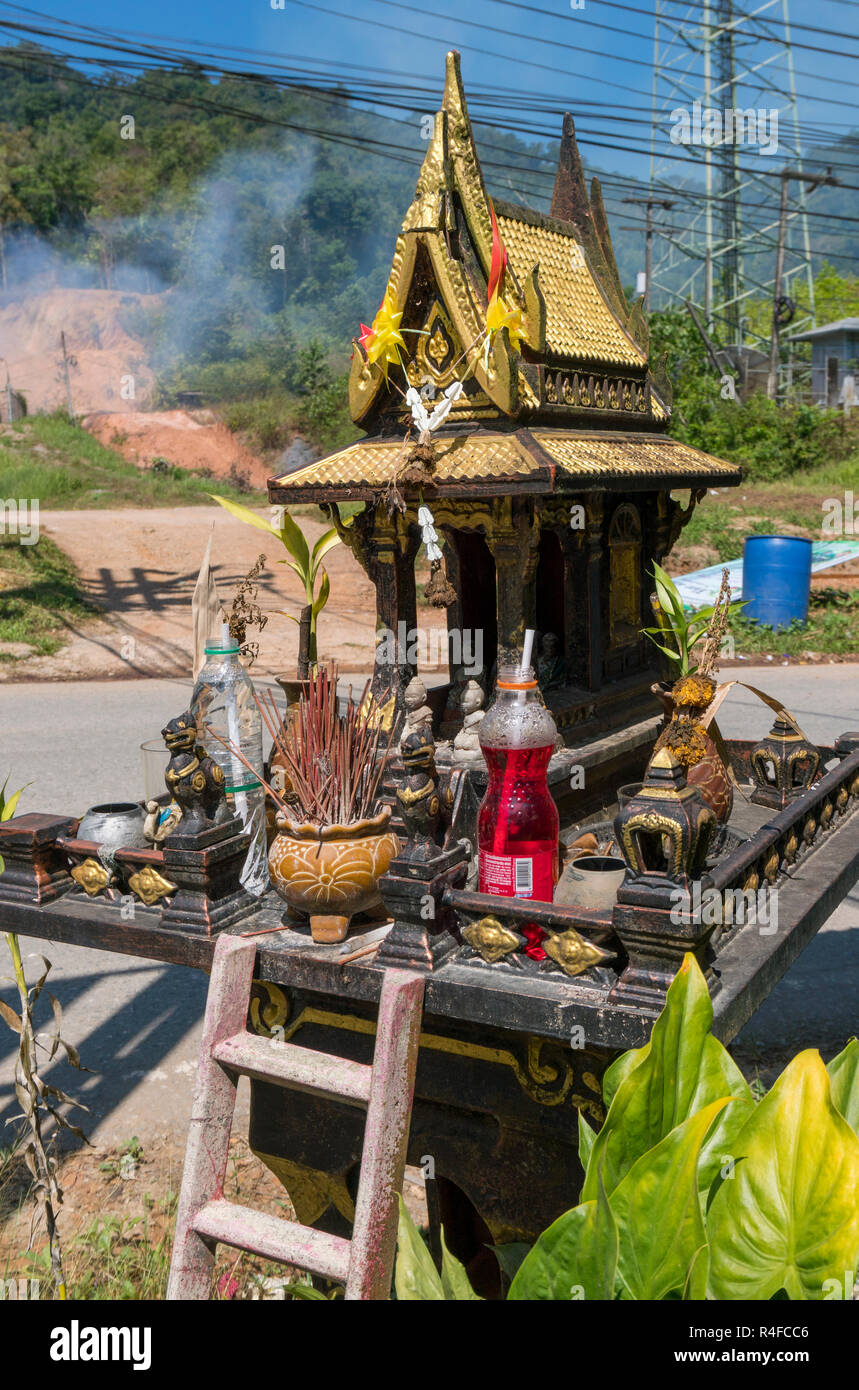 Golden Buddhist altar on the street on rural countryside area, part of ...