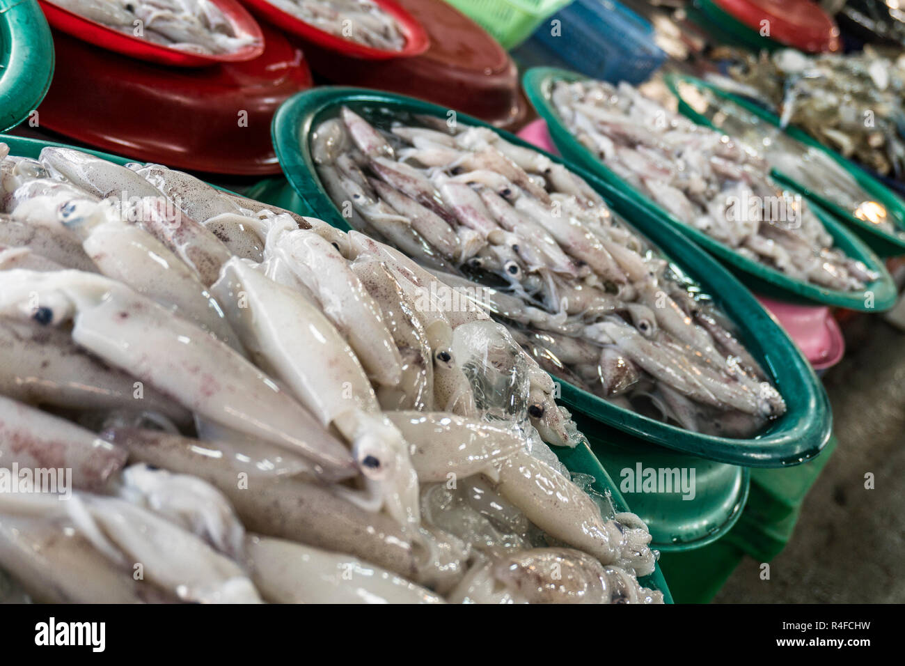 Fresh fish in baskets on the traditional Thai rural market. Seafood in ...