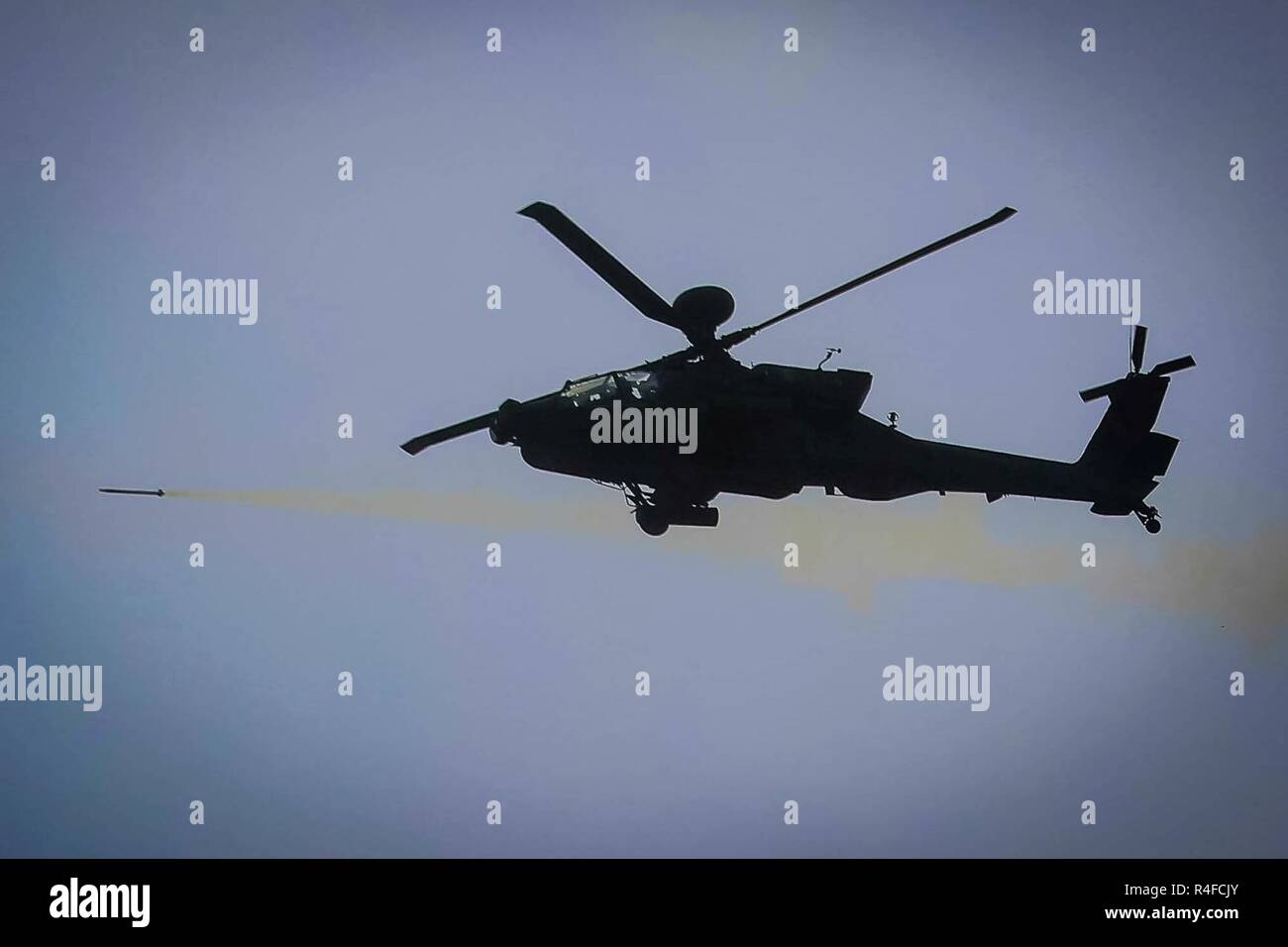 A rocket is launched from an AH-64D Apache helicopter assigned to 1st ...
