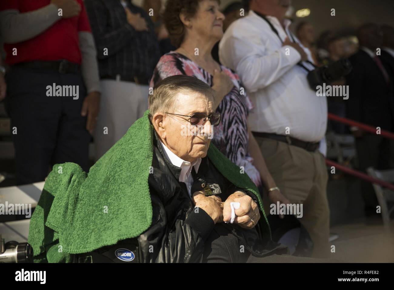 Larry L. Cooper Jr. places his hand over his heart during the national ...