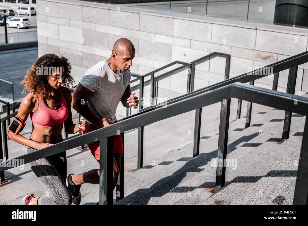 Nice sportive people running up the stairs Stock Photo - Alamy