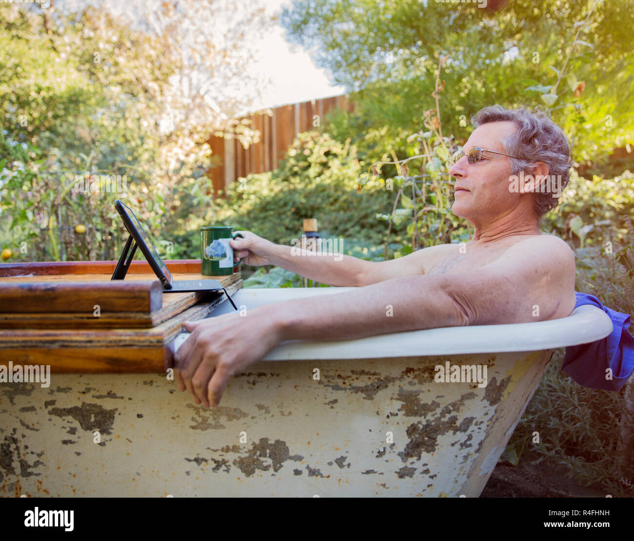 A Mature Man Chilling in Outdoor in Bathtub Stock Photo - Alamy