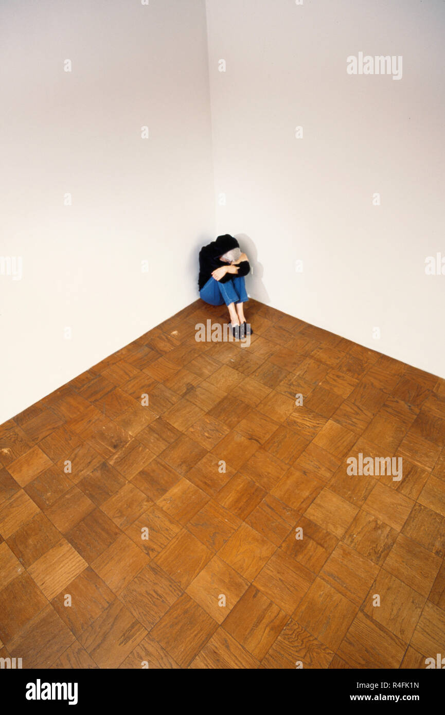 Depressed woman crying in a corner, USA Stock Photo - Alamy