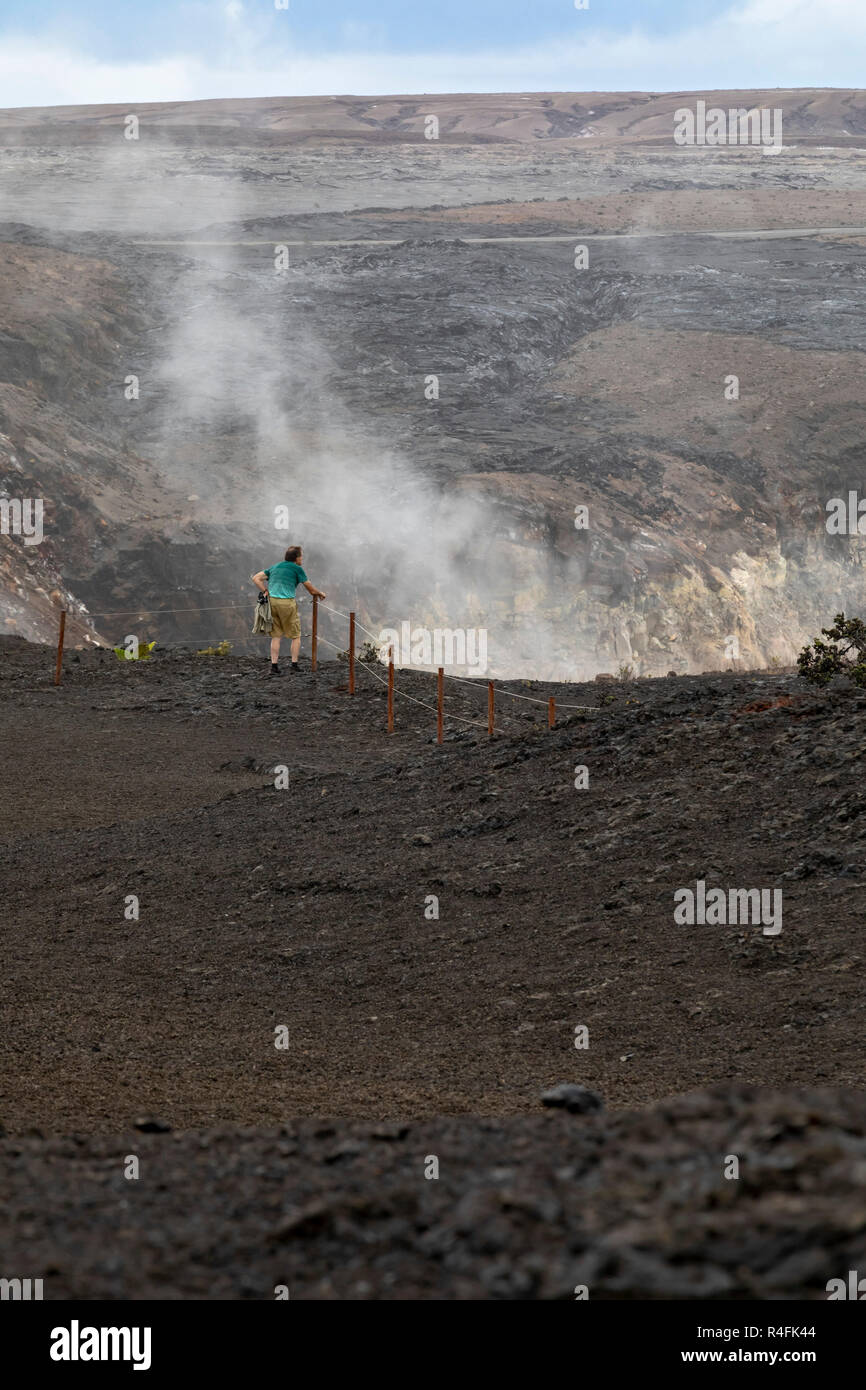 Hawaii Volcanoes National Park, Hawaii - A man looks over the Kilauea ...