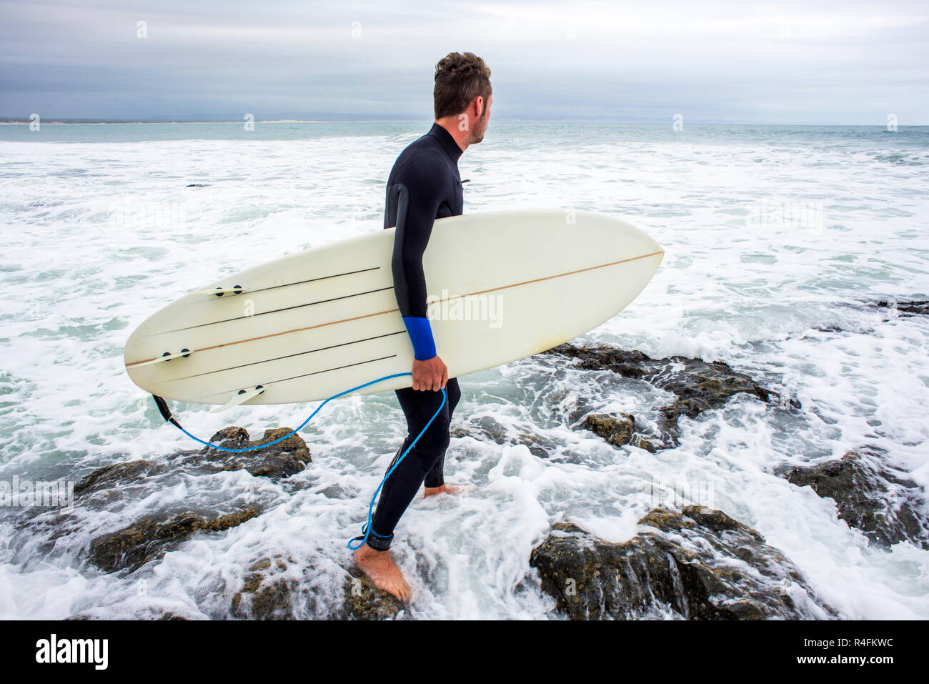 Surfer Entering the Surf with Surfboard Stock Photo - Alamy