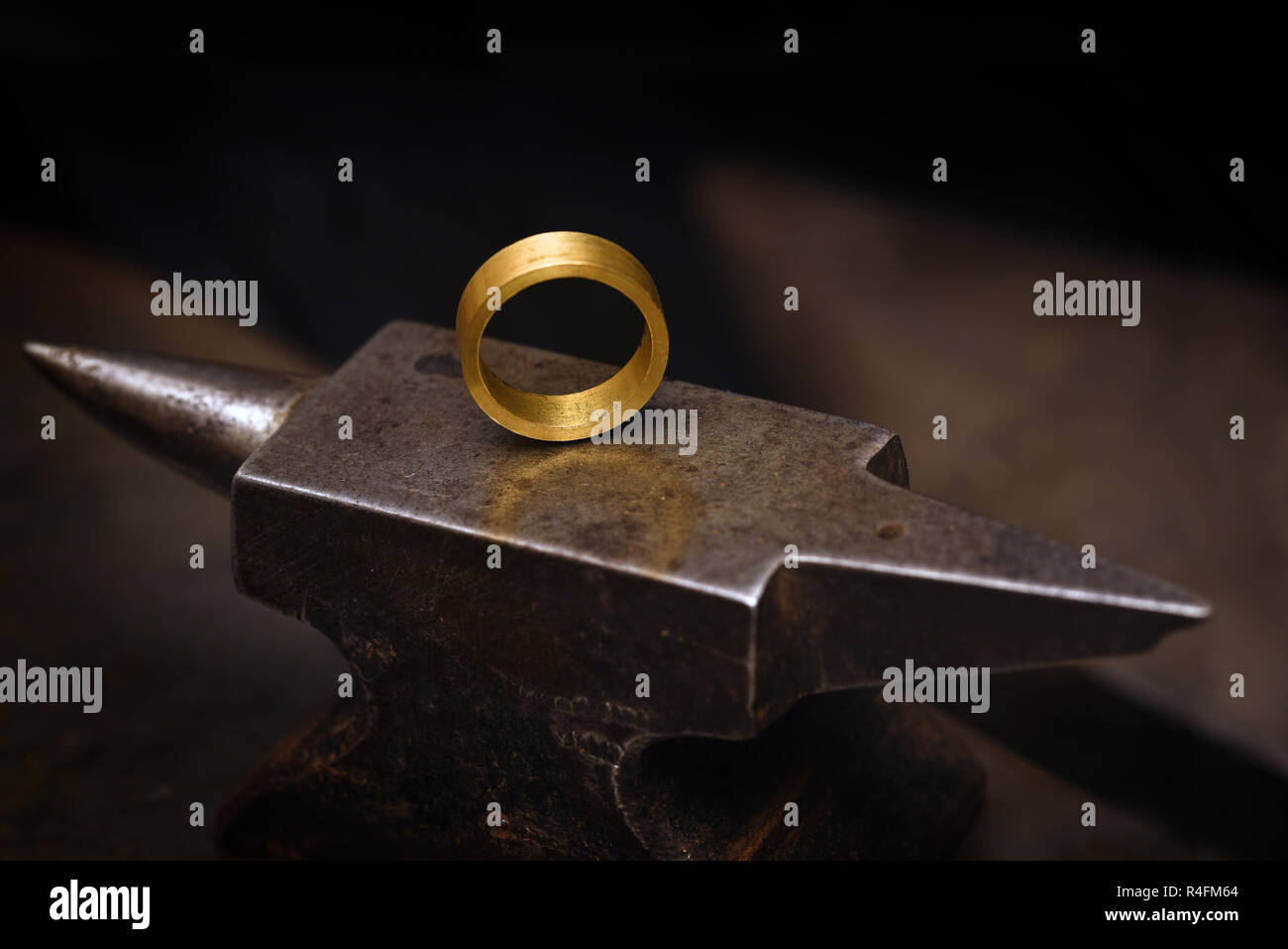 ring from gold on a goldsmith anvil in the jewelry manufactory, still ...