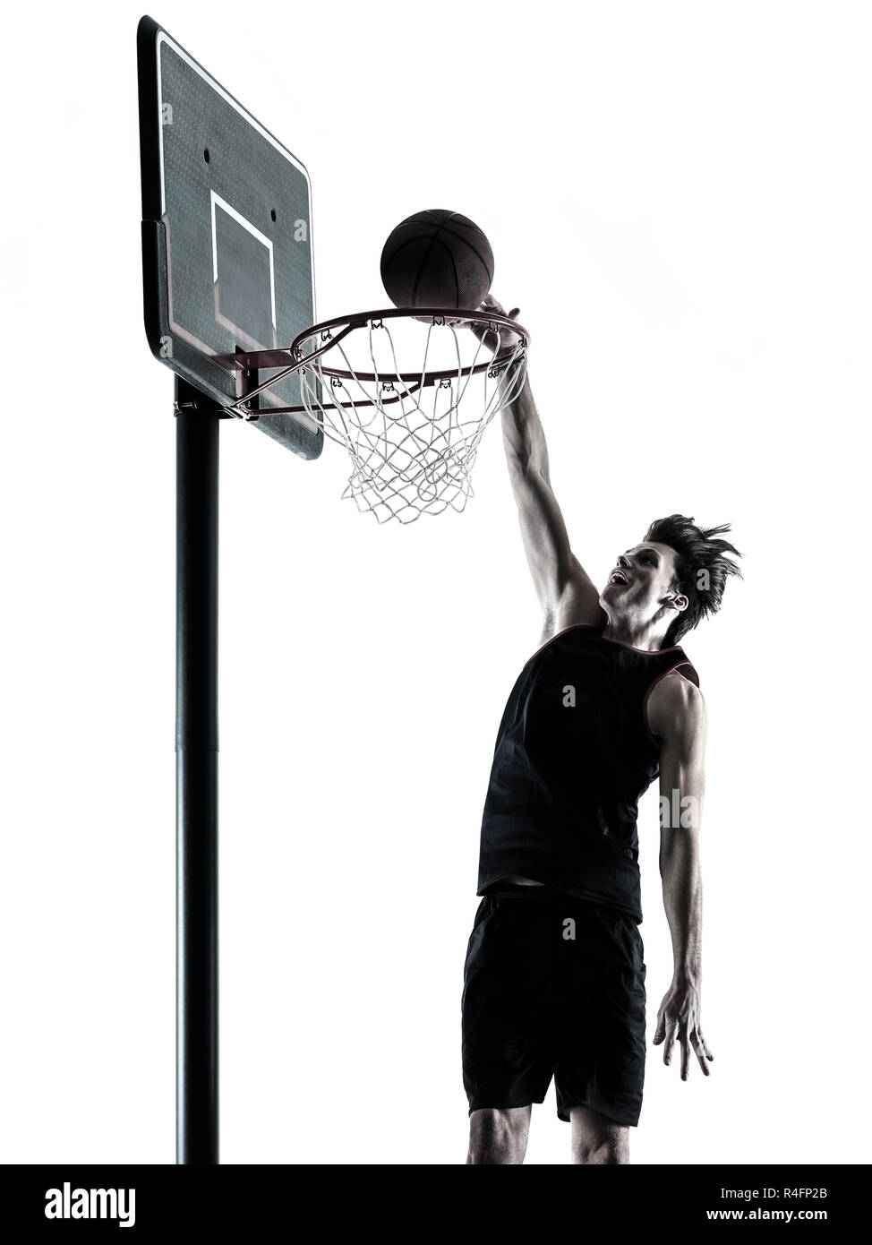 one caucasian basketball player man isolated in silhouette shadow on ...