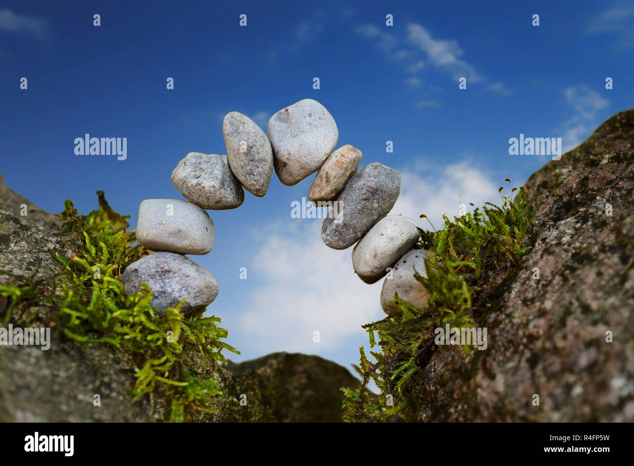 balanced stone arch of pebbles as zen symbol for a bridge or a gate ...