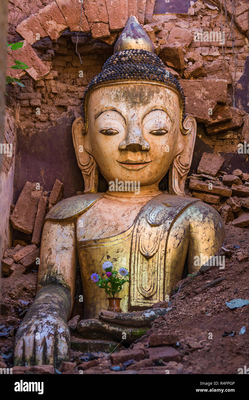 Buddha statue hiding in the ruins of the Shwe Inn Dein Pagoda at Inle ...