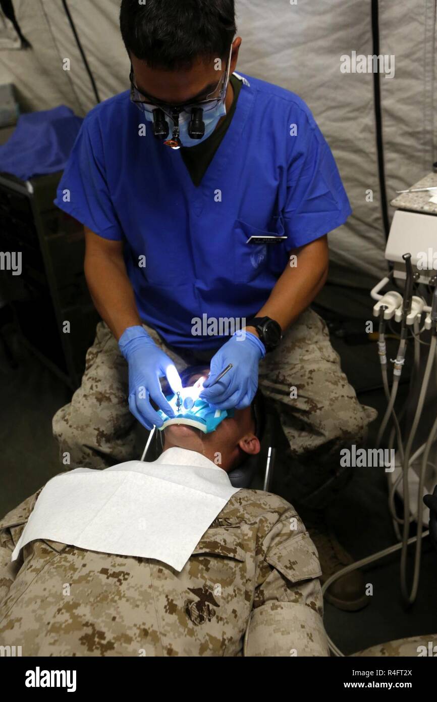 U.S. Navy Lt. Rodney Martin examines a patient who is set to get a ...