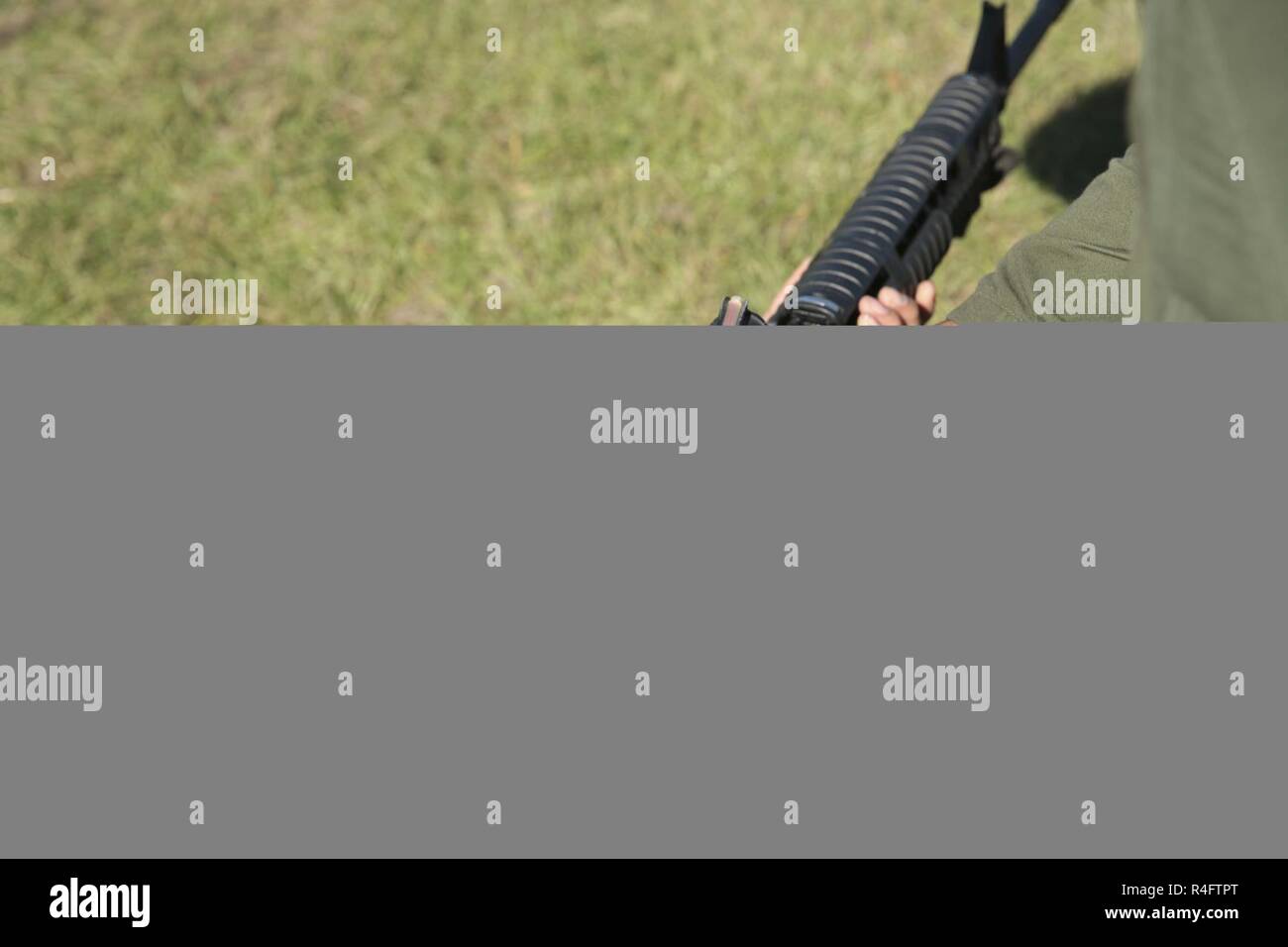 U.S. Marine Sgt. Miguel Davila, primary marksmanship instructor, adjust ...