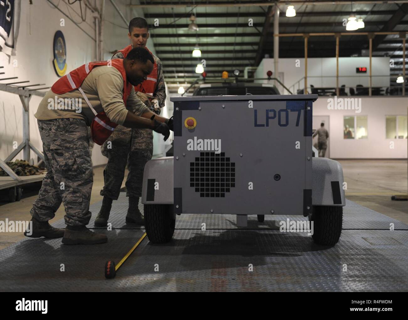 U.S. Air Force Staff Sgt. Adrian Marsh, front, and Airman 1st Class ...