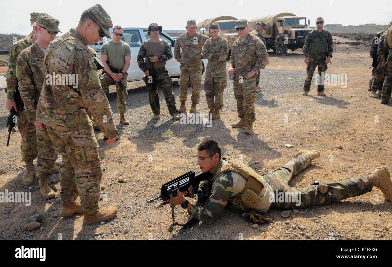 A French service member demonstrates how to use the Famas, an assault ...