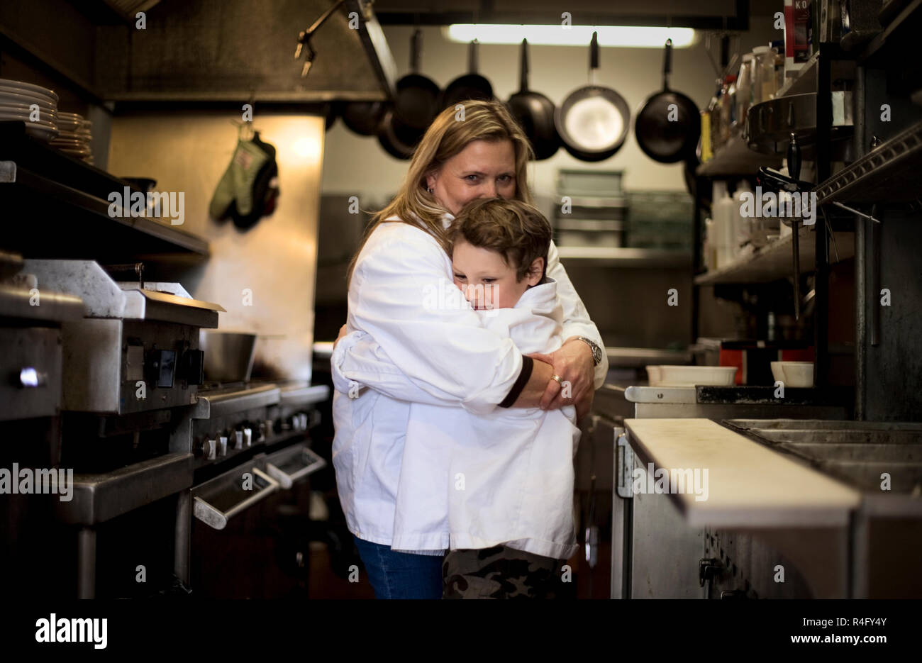 Side view of a woman and a boy embracing Stock Photo - Alamy
