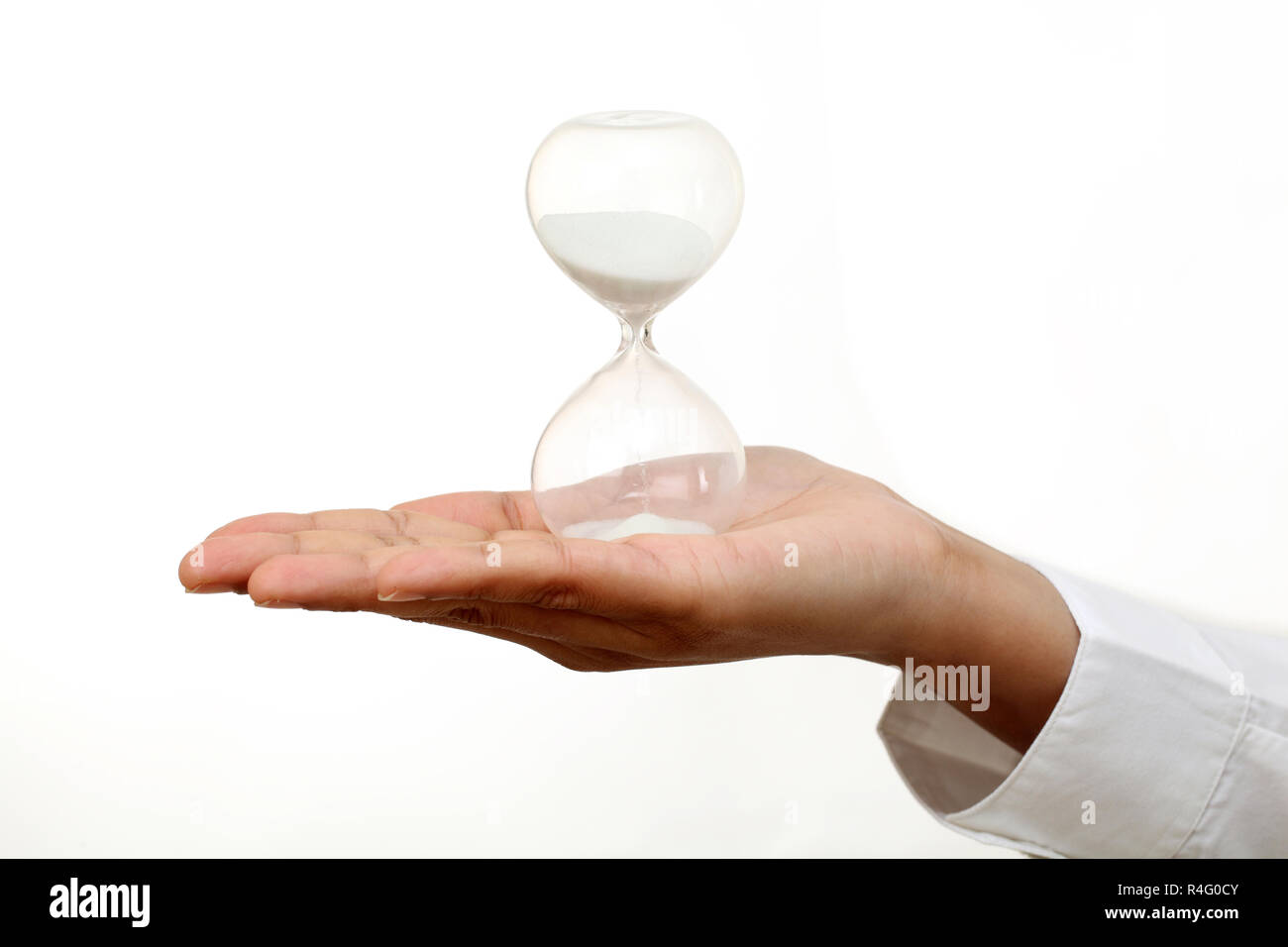Business woman hand holding hourglass against white Stock Photo - Alamy