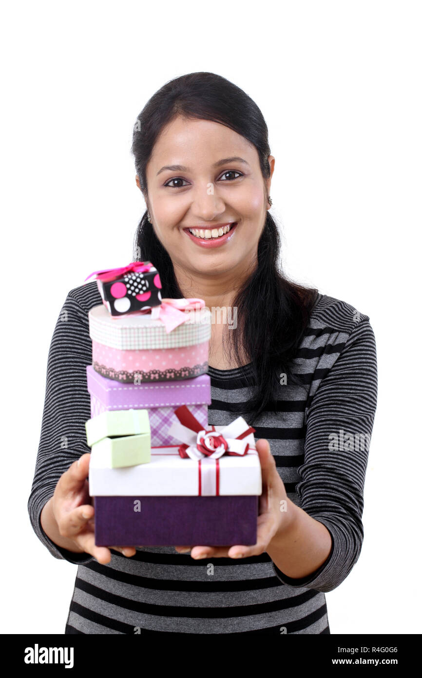 Young woman holding boxes against white Stock Photo - Alamy