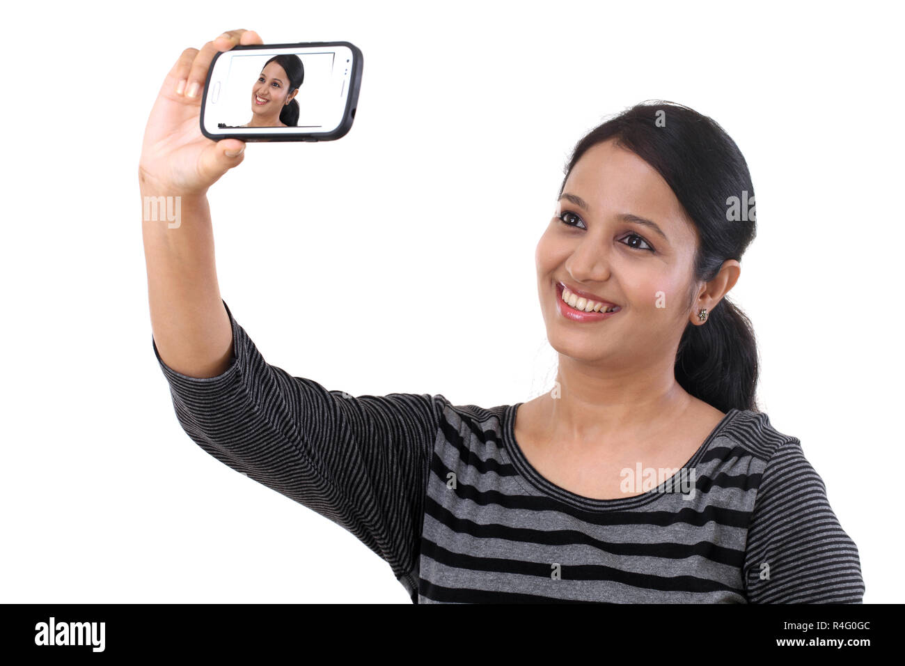 Happy woman taking a selfie Stock Photo - Alamy