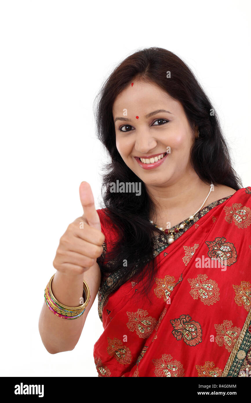 Cheerful traditional young Indian woman showing thumbs up gesture Stock ...